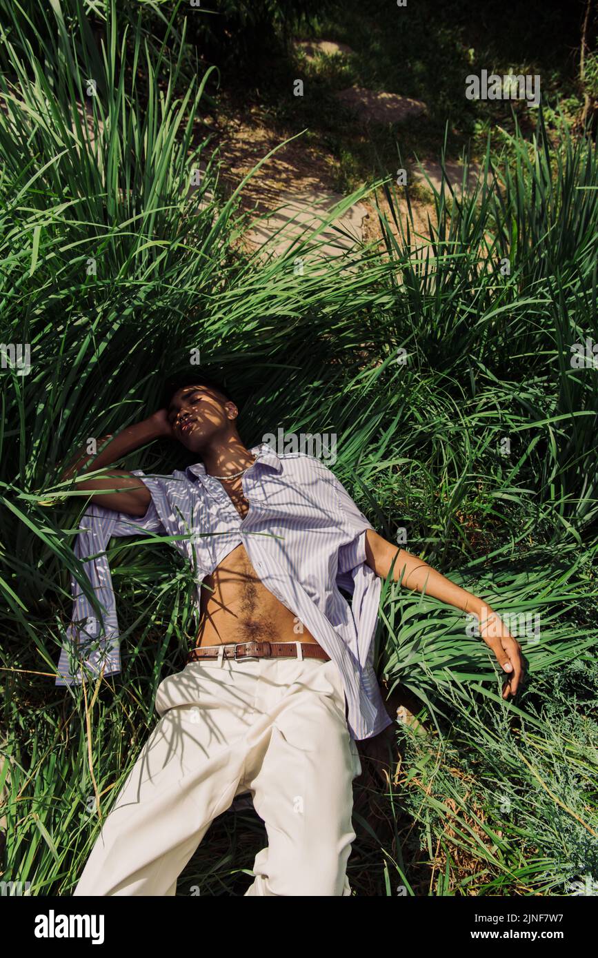 Young man sleeping grass hi-res stock photography and images - Alamy