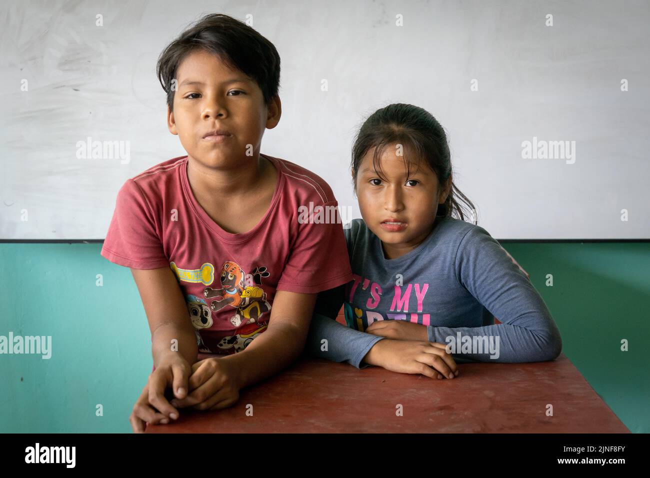 Riberenos students pose behind a donated desk and chair at their school ...