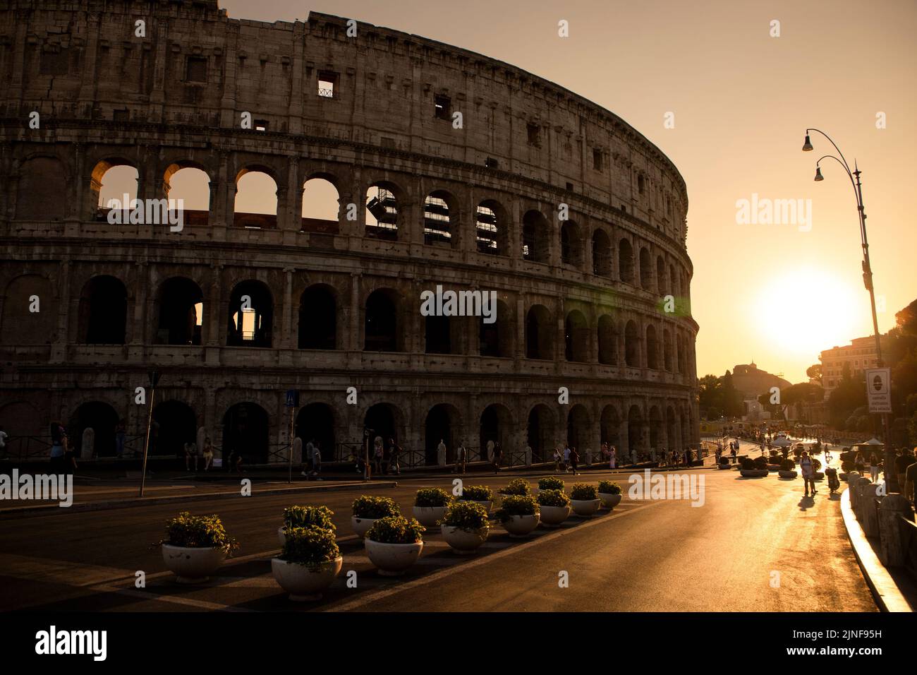 Colosseum in Rome, Italy under the sun at sunset Stock Photo - Alamy