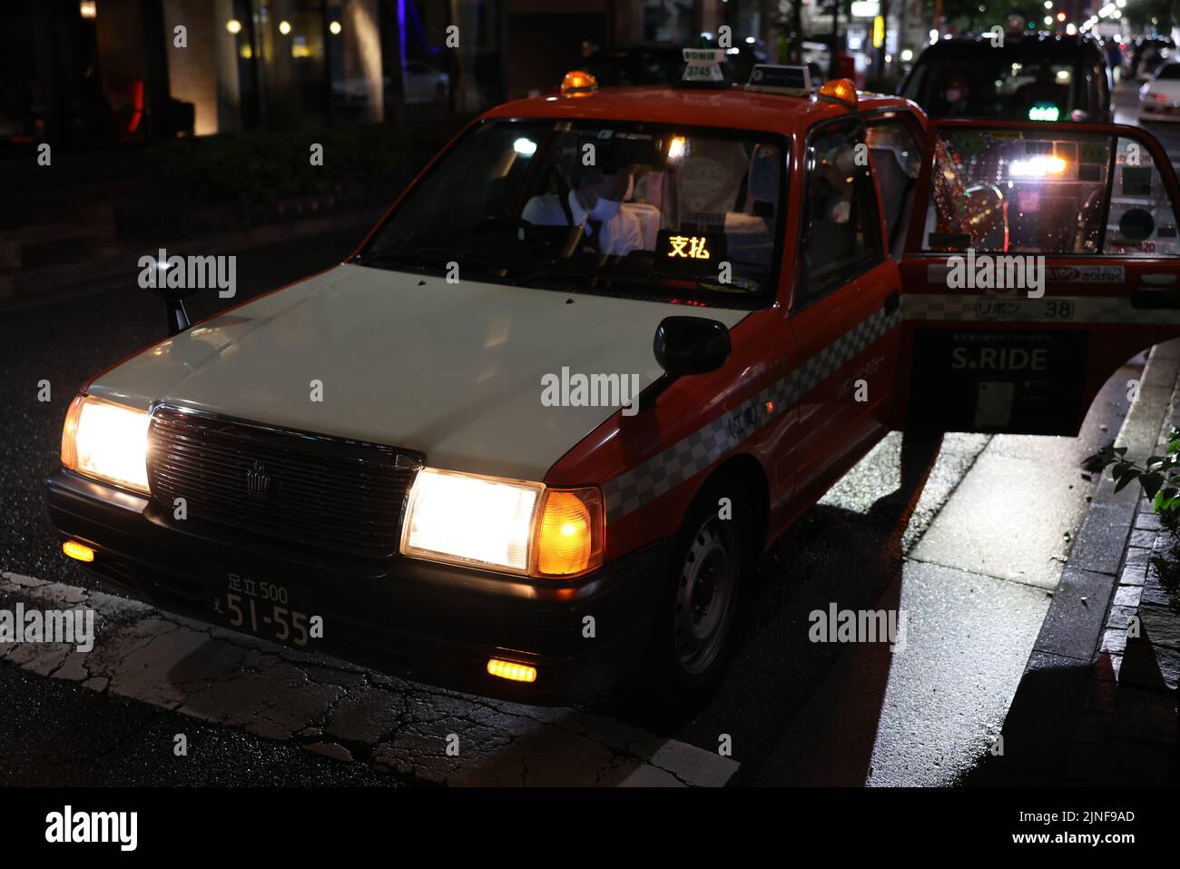 A random Japanese Taxi awaiting customer pickup Stock Photo - Alamy