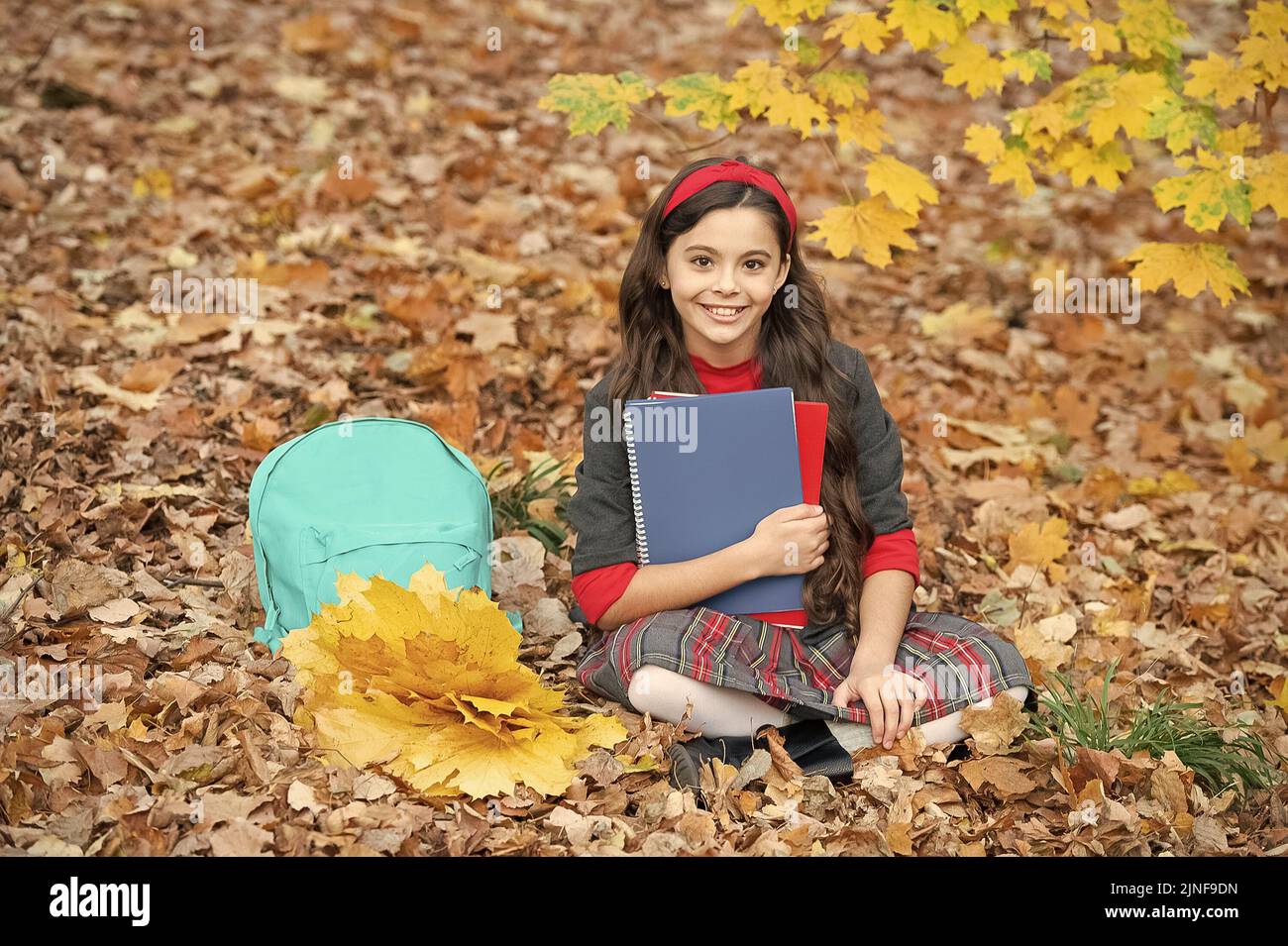 teen girl in school uniform hold autumn leaves. happy child with maple ...
