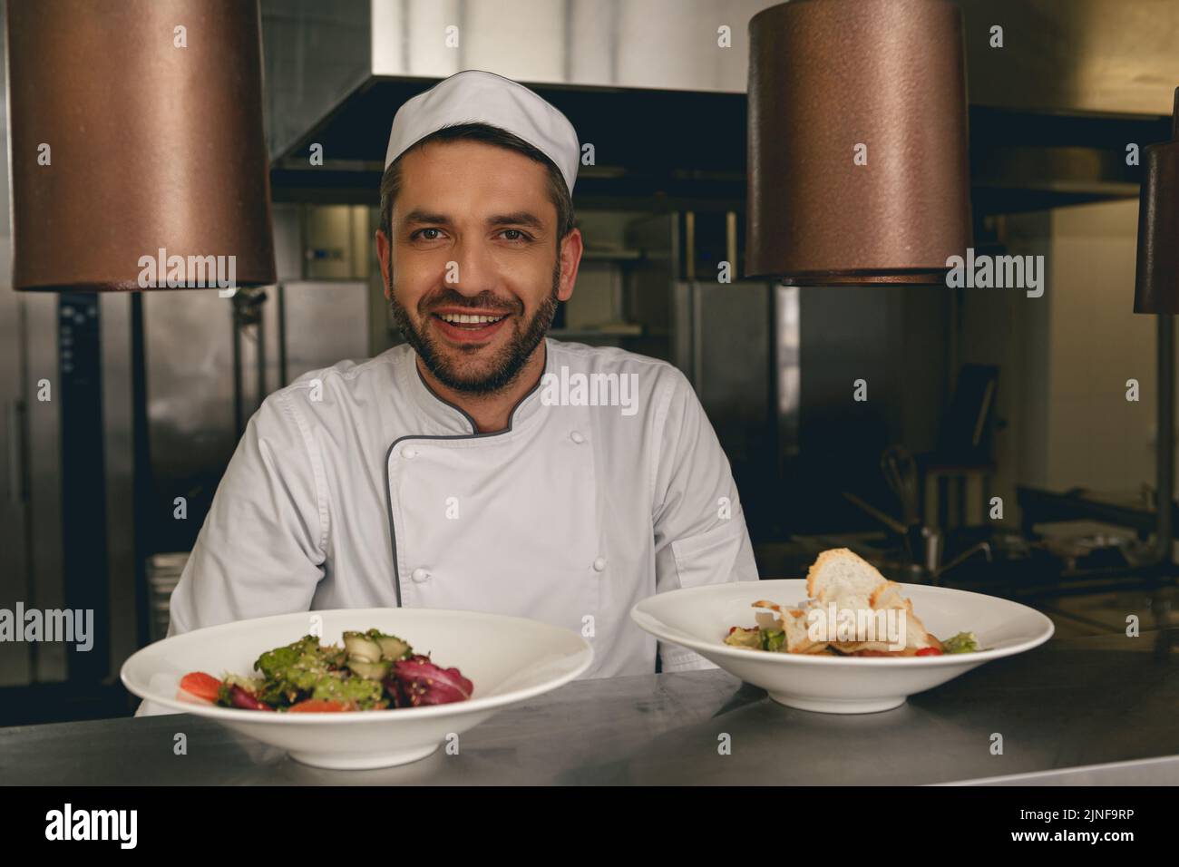 Professional chef checks dish just before serving it to customer in ...