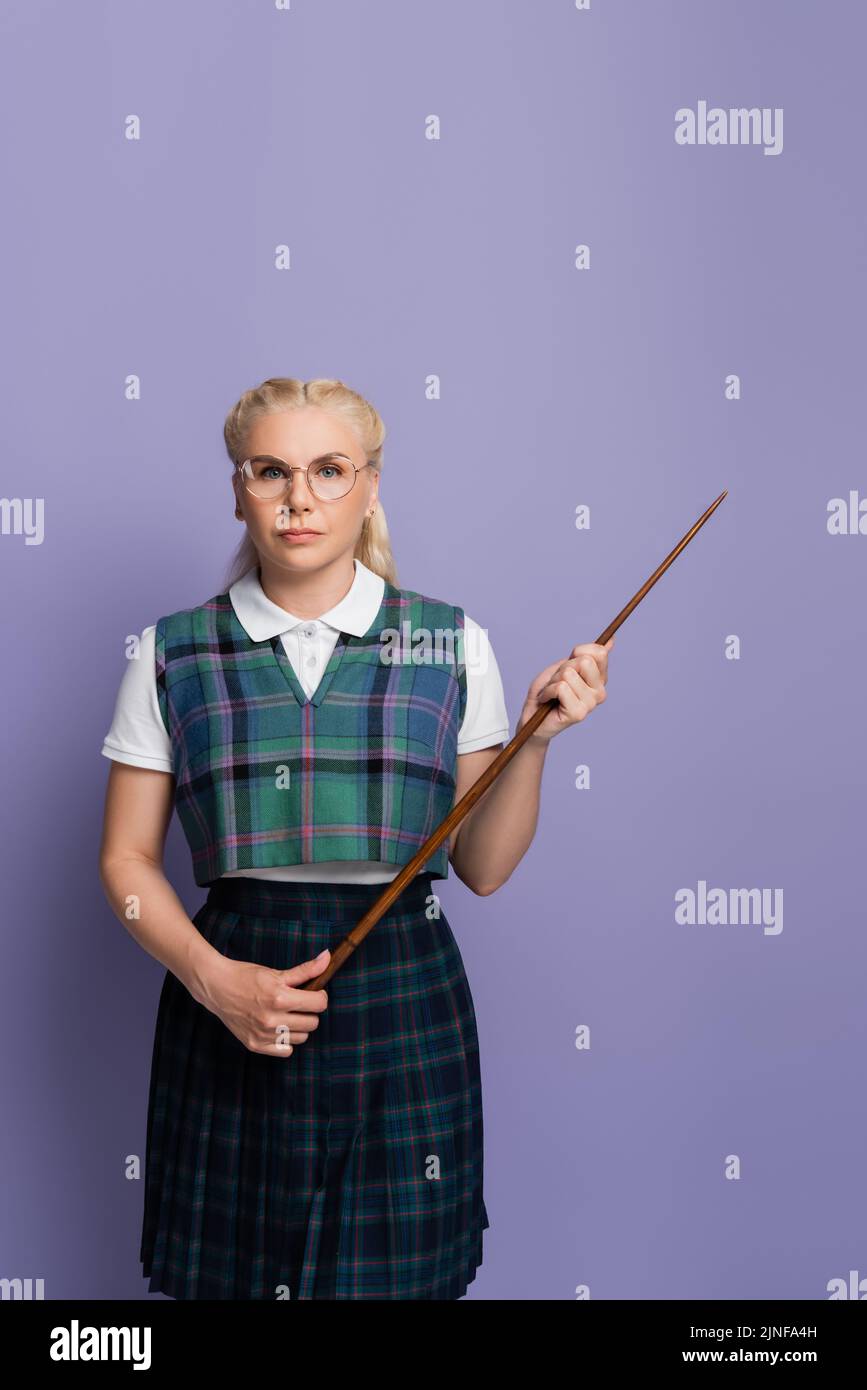 Blonde student in uniform and eyeglasses holding pointer isolated on ...