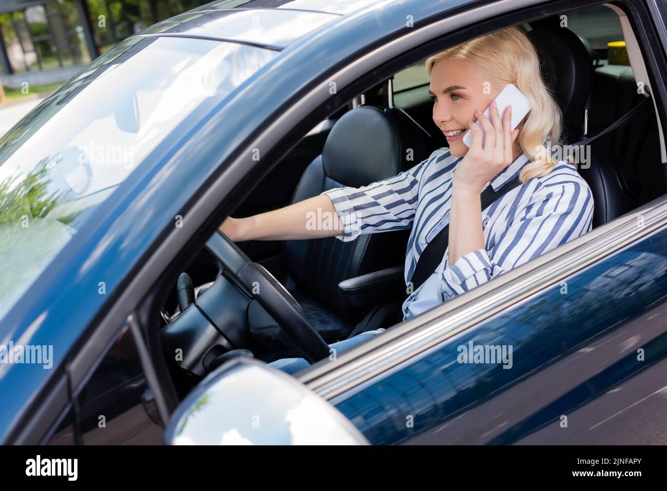 Positive driver talking on mobile phone while driving car,stock image ...