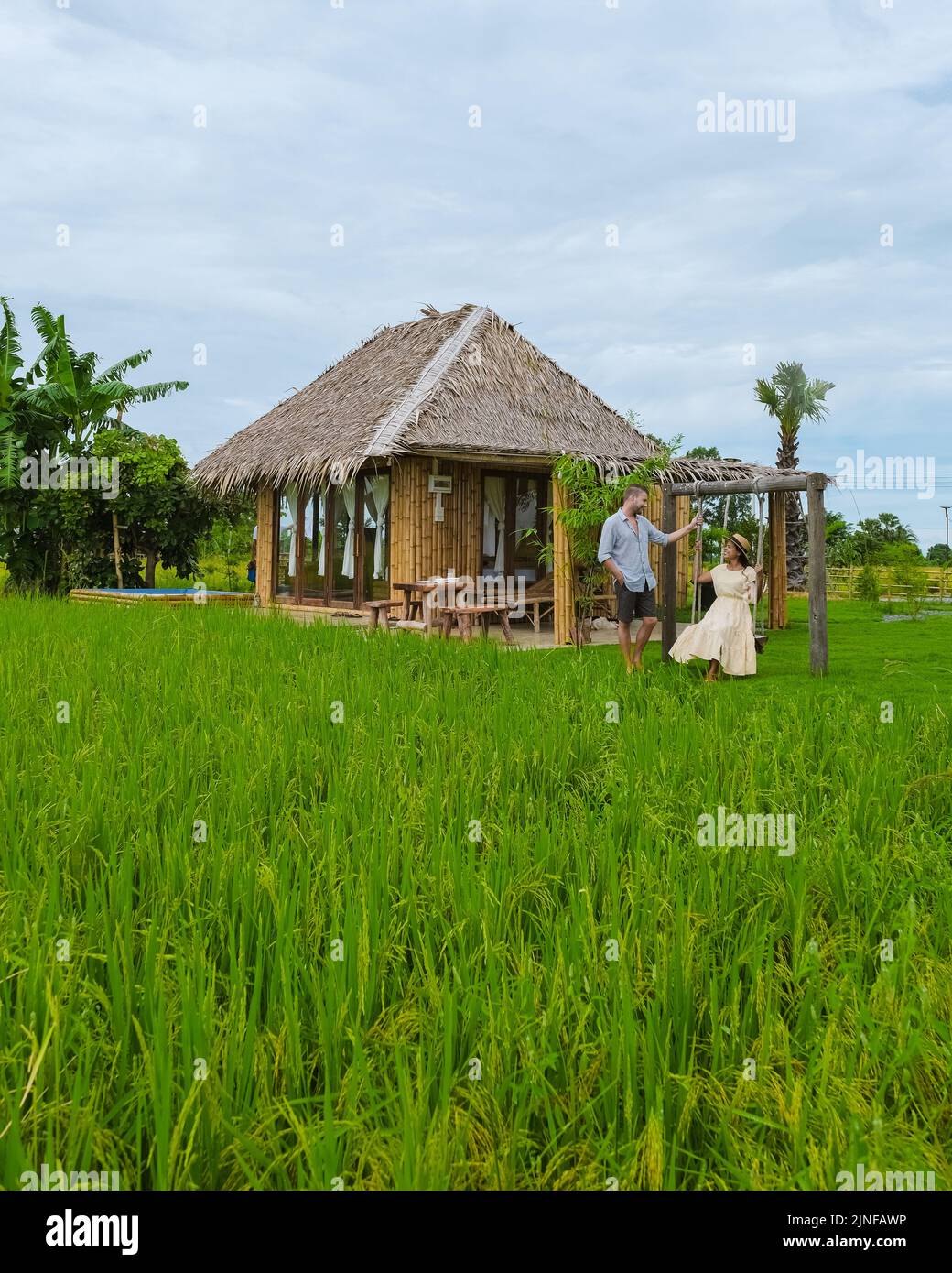 couple men and women on vacation at a homestay in Thailand, eco farm ...