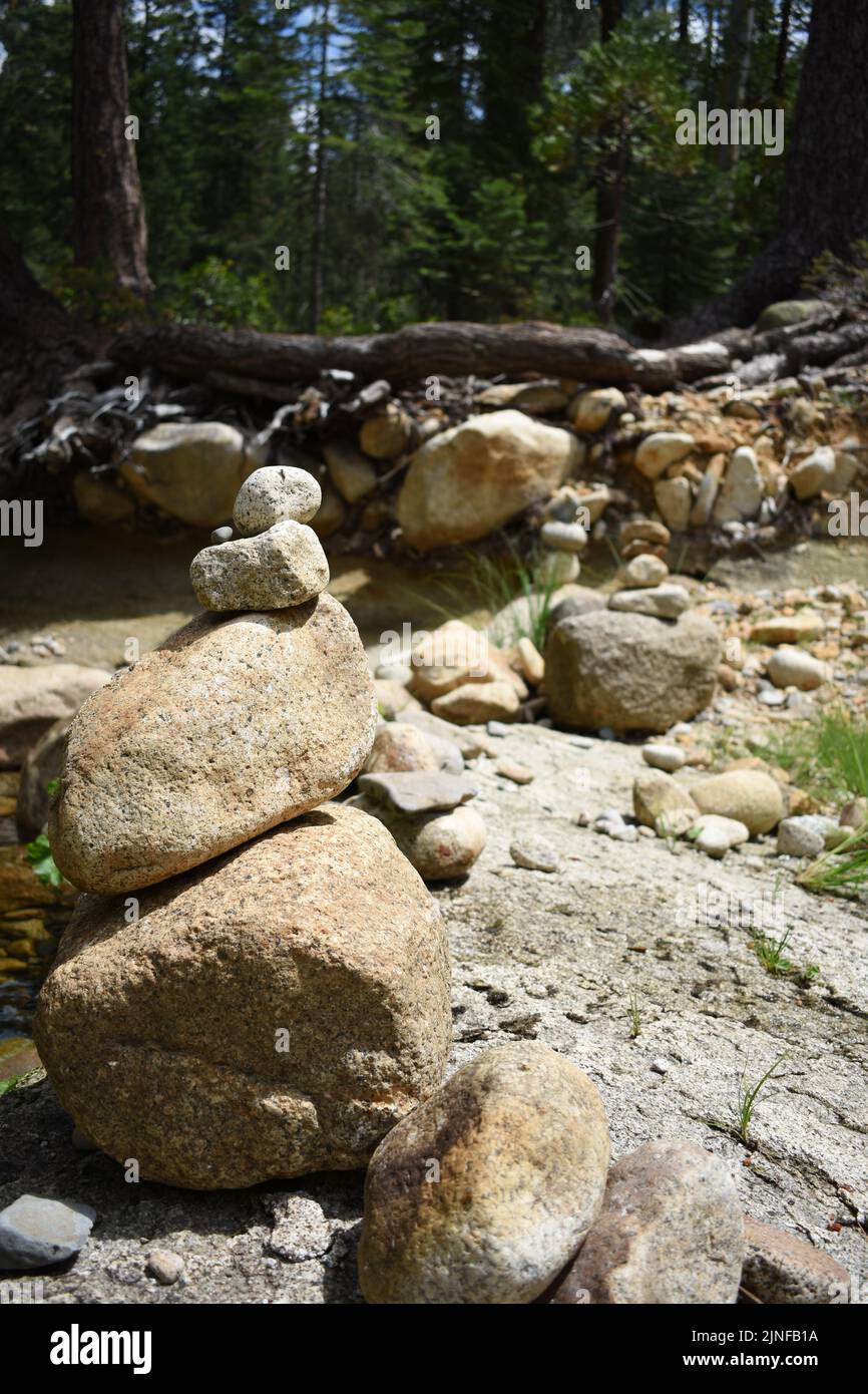 Stones stacked on top of each other in the forest Stock Photo - Alamy