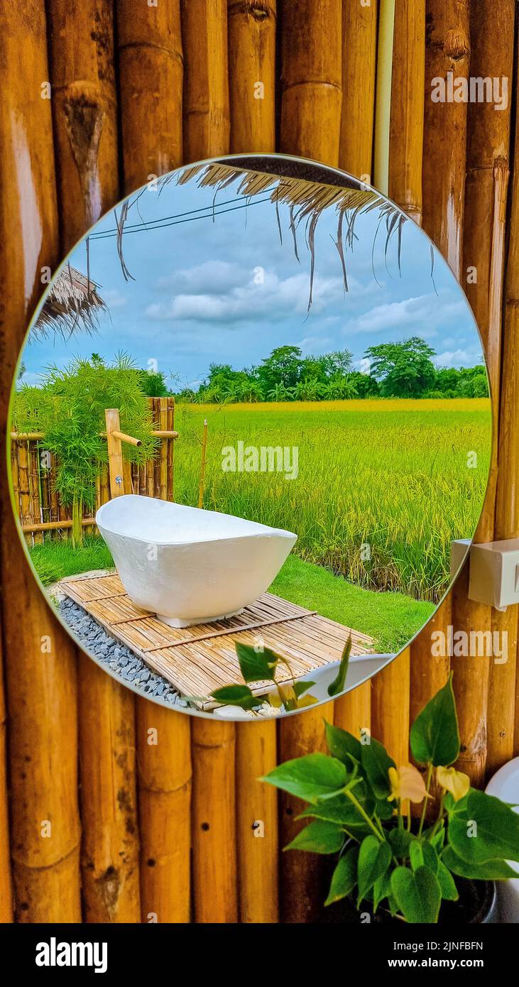white bathtub outside looking out over a green rice field, bath tub ...