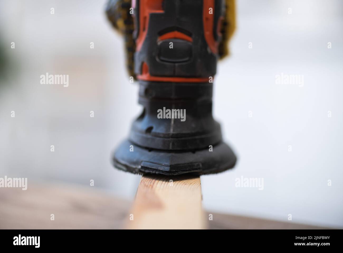 Close up view of blurred electric sander on wooden board at home,stock ...