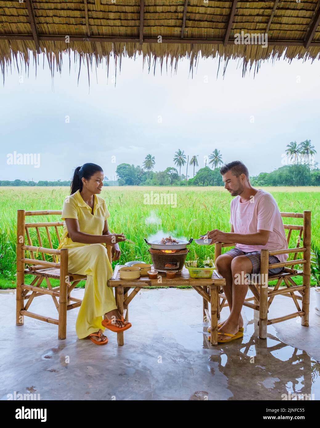 couple men and women having a Korean bbq on vacation at a homestay in ...