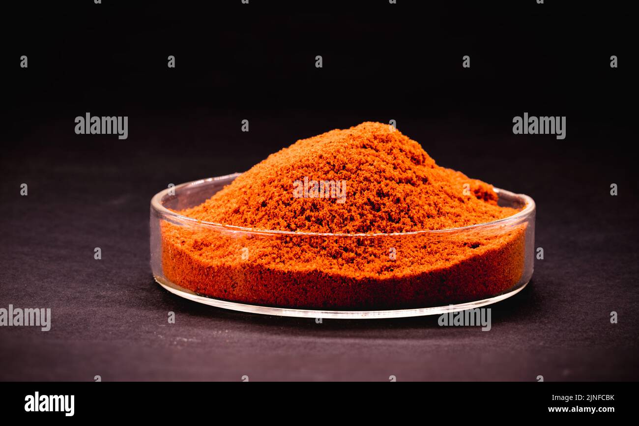 red pigment powder with black background, industrial use in synthetic ...