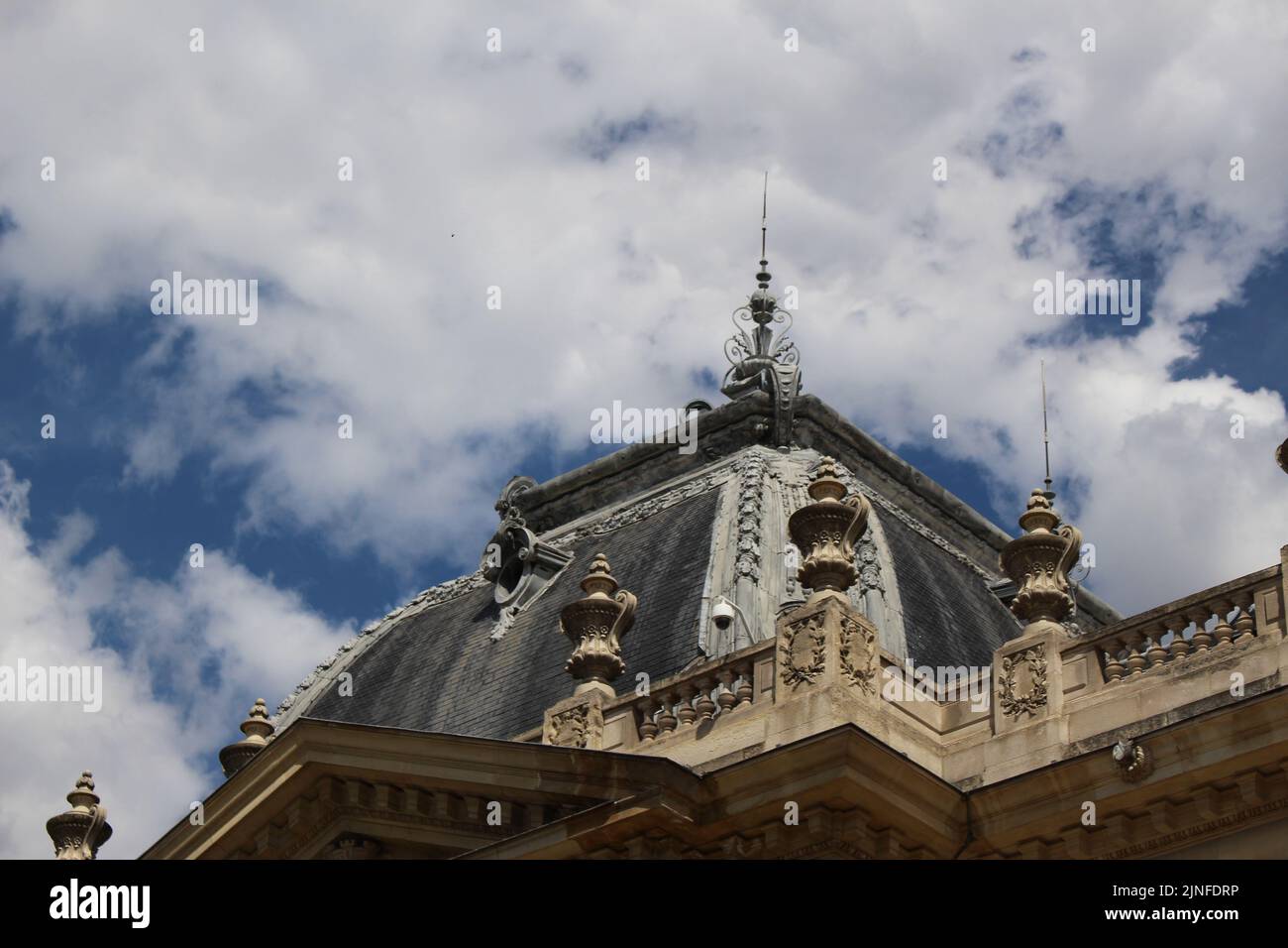 Classic French rooftop architecture against cloudy summer sky. Copy ...