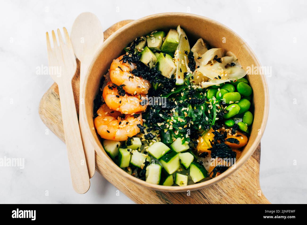 Shrimp poke bowls with seaweed, avocado, mango, cucumber, rice, pickled ...