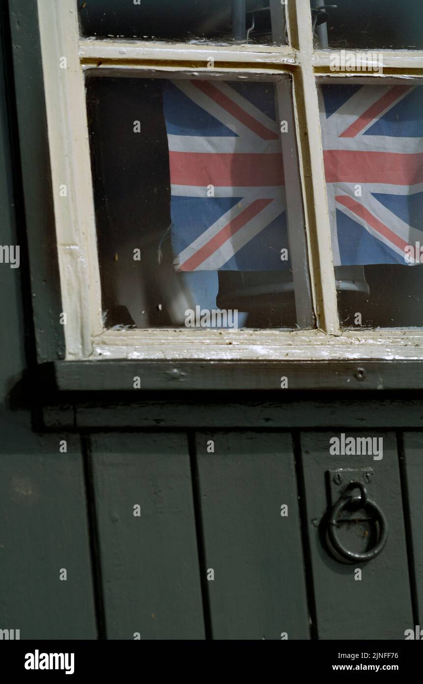 union jack flag in old shed window Stock Photo - Alamy