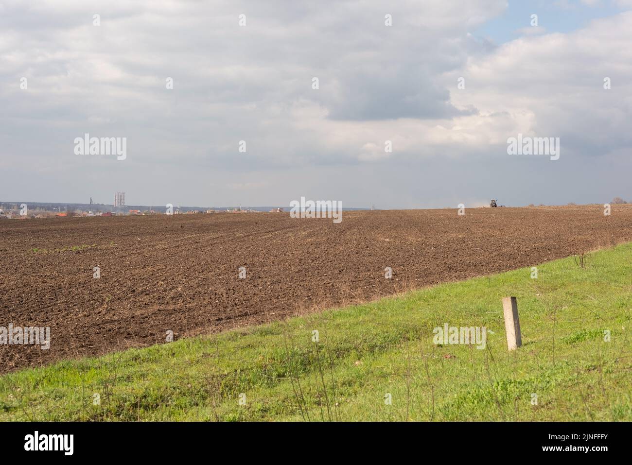 minimalistic landscape field plowed land green grass Stock Photo - Alamy