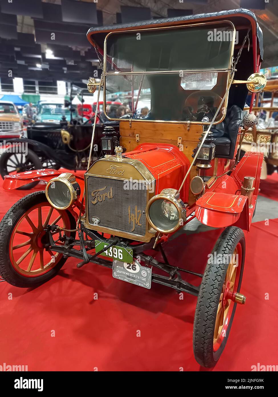 Old 1912 Ford Model T open runabout roadster on a red carpet. Exhibit ...