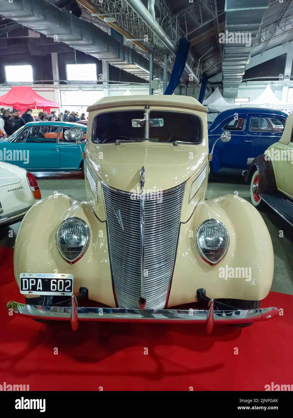 Old antique cream 1937 Ford V8 coupe cabriolet Deluxe on a red carpet ...