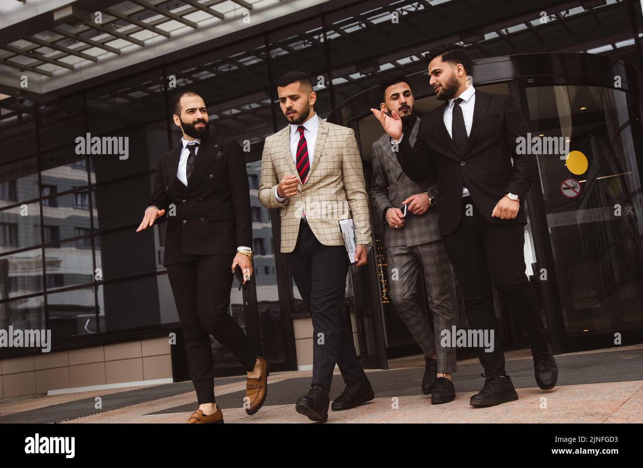 Business people outdoor meeting, A group of male businessmen in suits ...