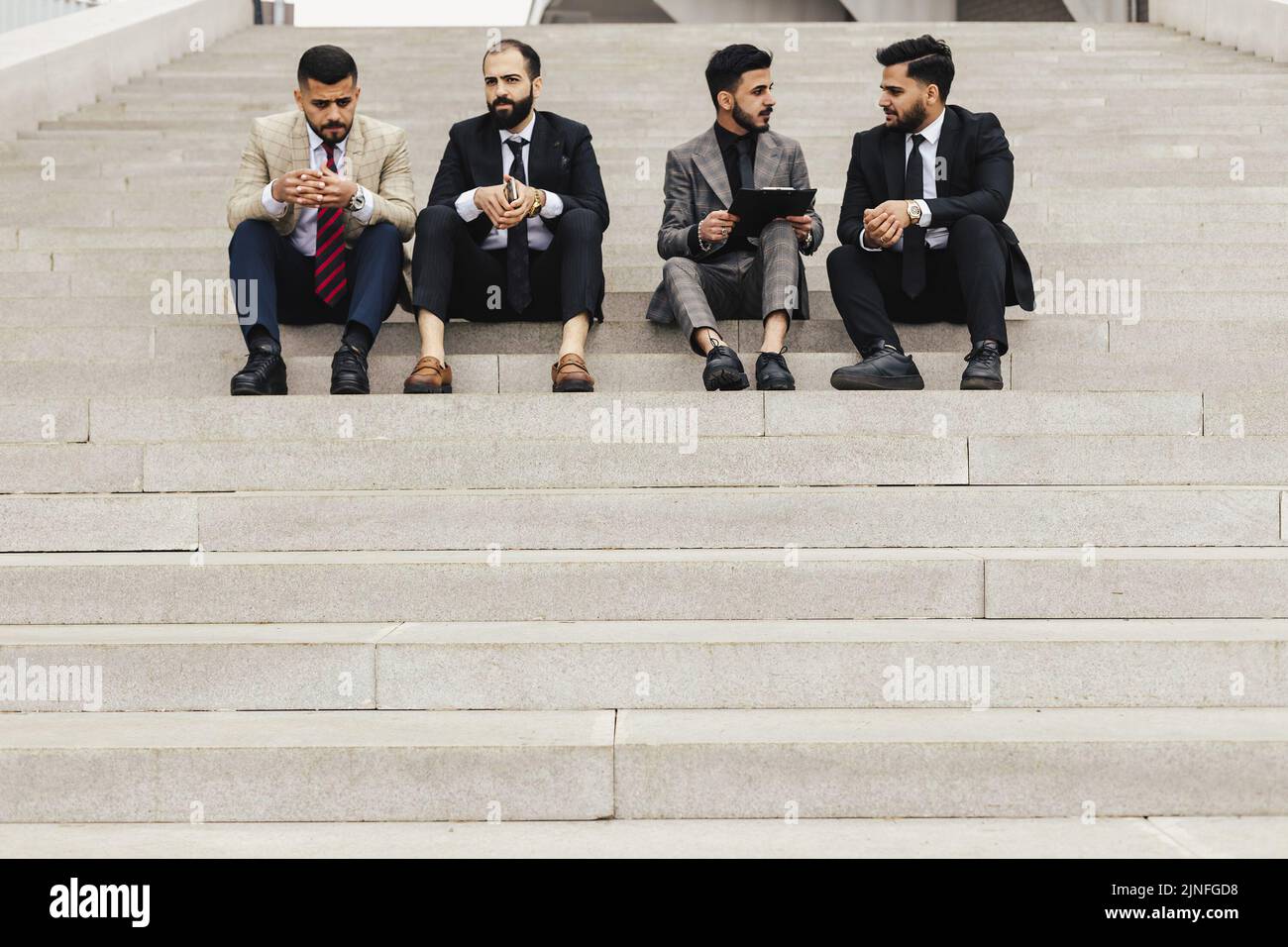 Group of colleagues sitting on steps hi-res stock photography and ...