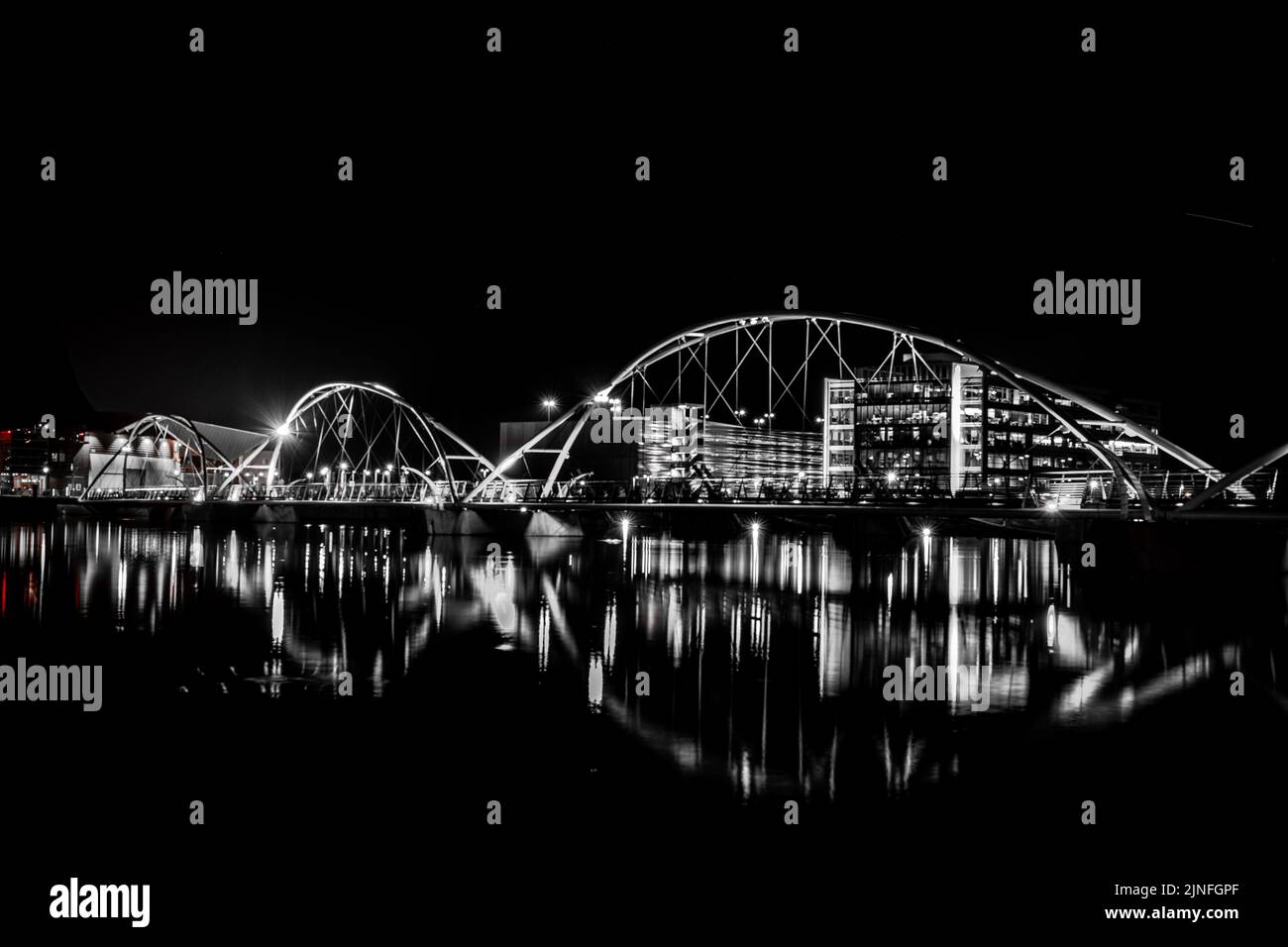 A grayscale shot of Tempe Town Lake Pedestrian Bridge at night. Arizona ...