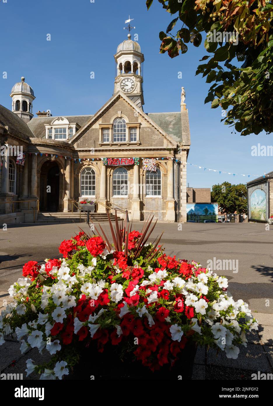 Thetford Guildhall and bell tower with flower planter on the Market ...