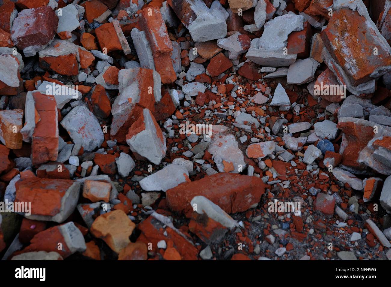 grey concrete stone with brocken red bricks on the background as a ...