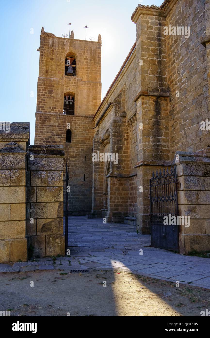 Medieval stone church with its bell-filled tower at sunset on a sunny ...