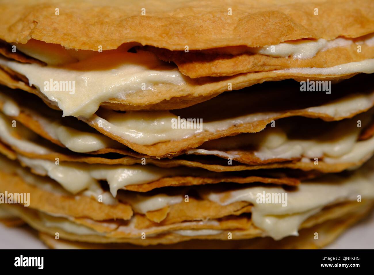 Puff pastry cake Napoleon layers closeup texture with white cream ...