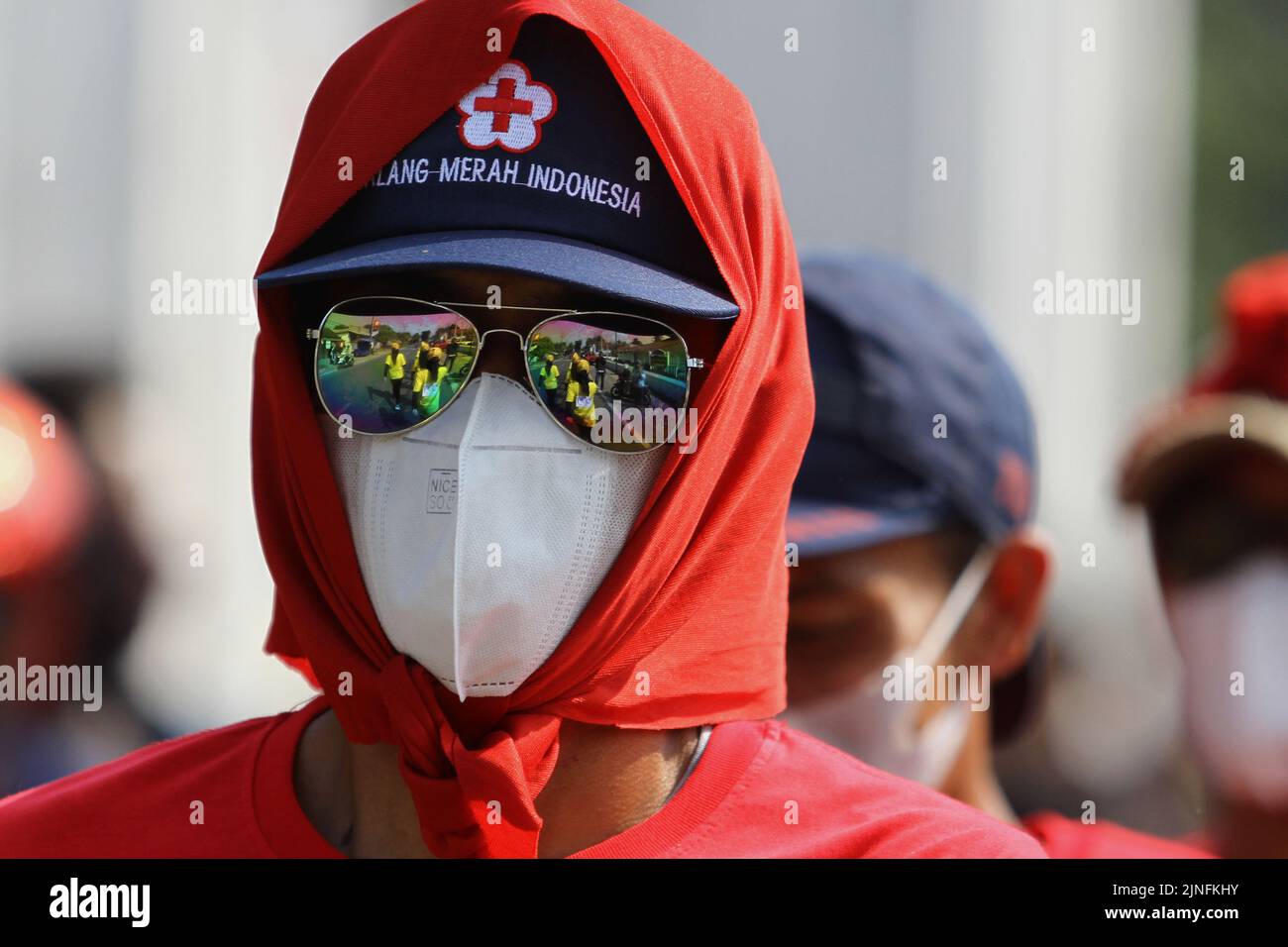 A participant wearing an Indonesian cap takes part in a marching ...