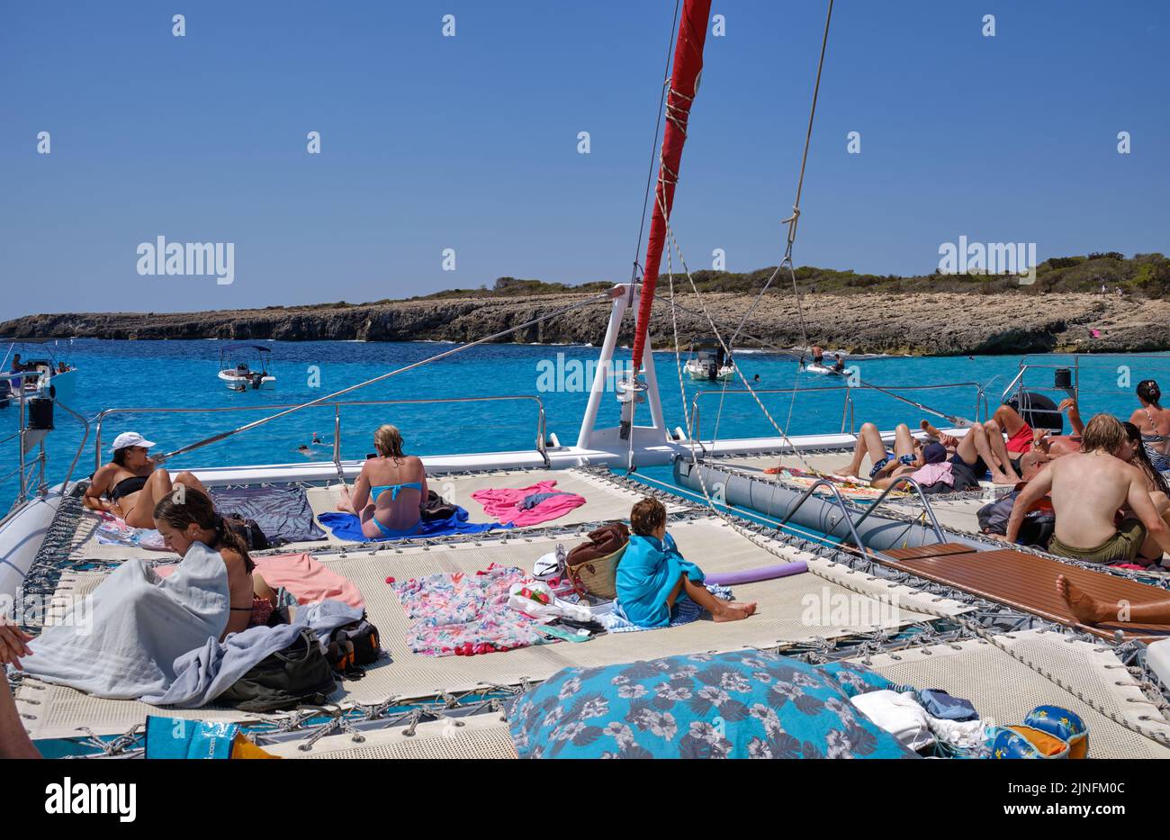 Menorca, Spain: Beautiful bay with sailing boat catamaran Stock Photo ...