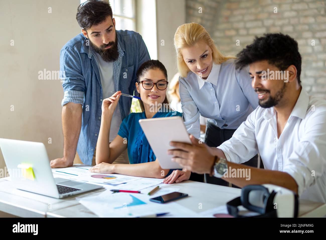 Group of happy multiethnic business people cooperating, working on ...