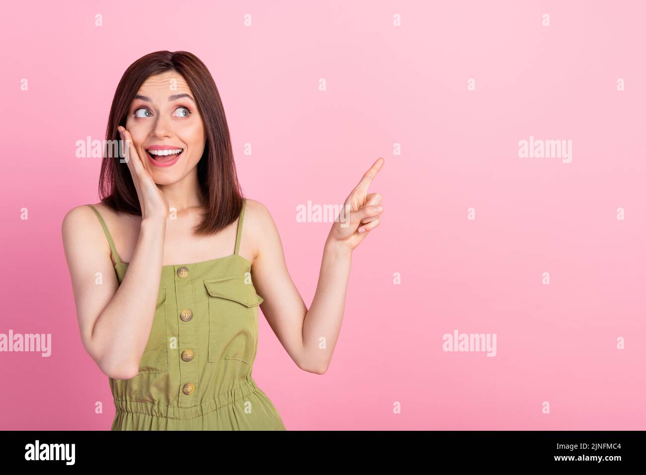 Photo of pretty positive lady sit interested look empty space hold ...