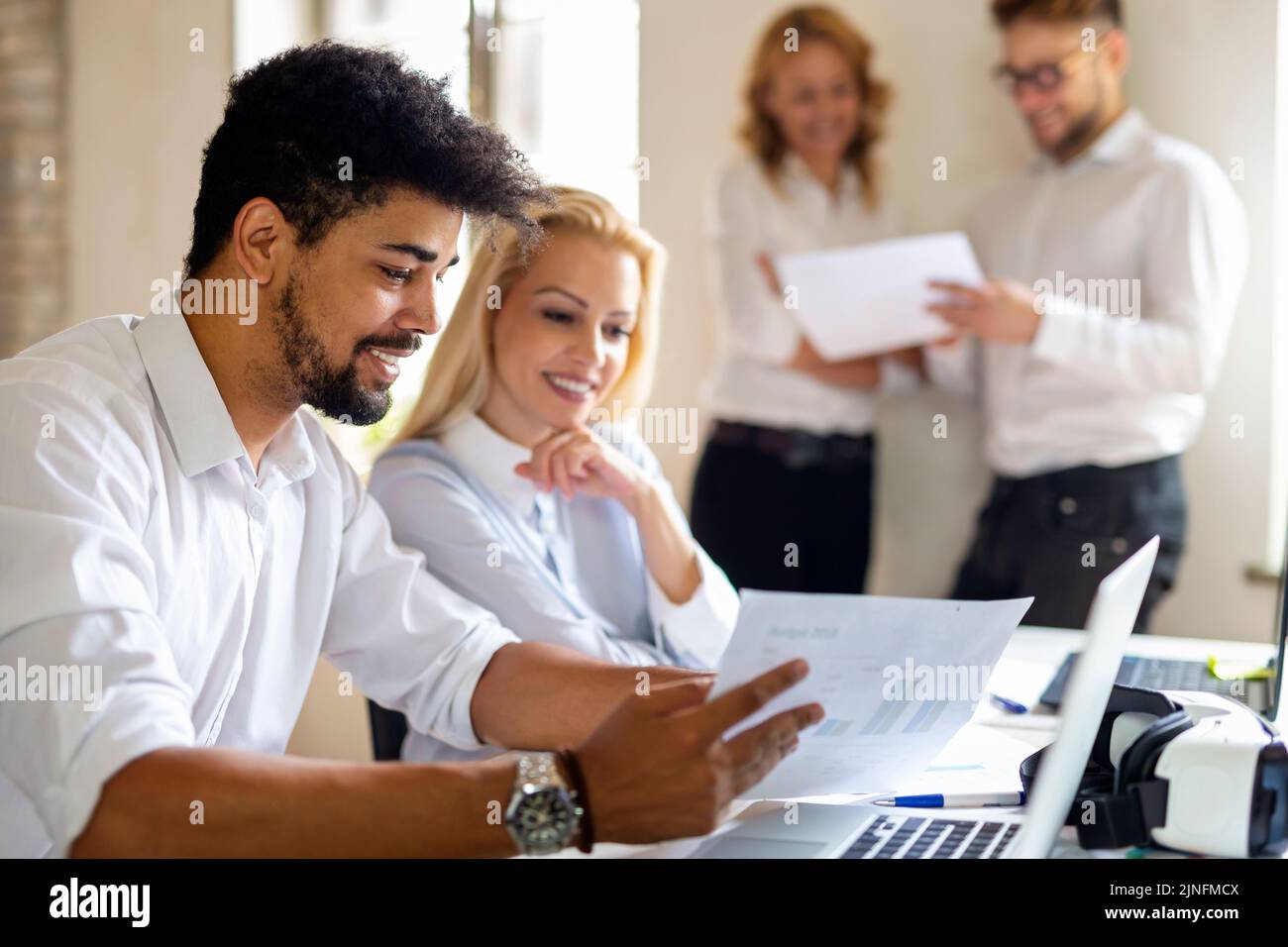 Group of happy multiethnic business people cooperating, working on ...