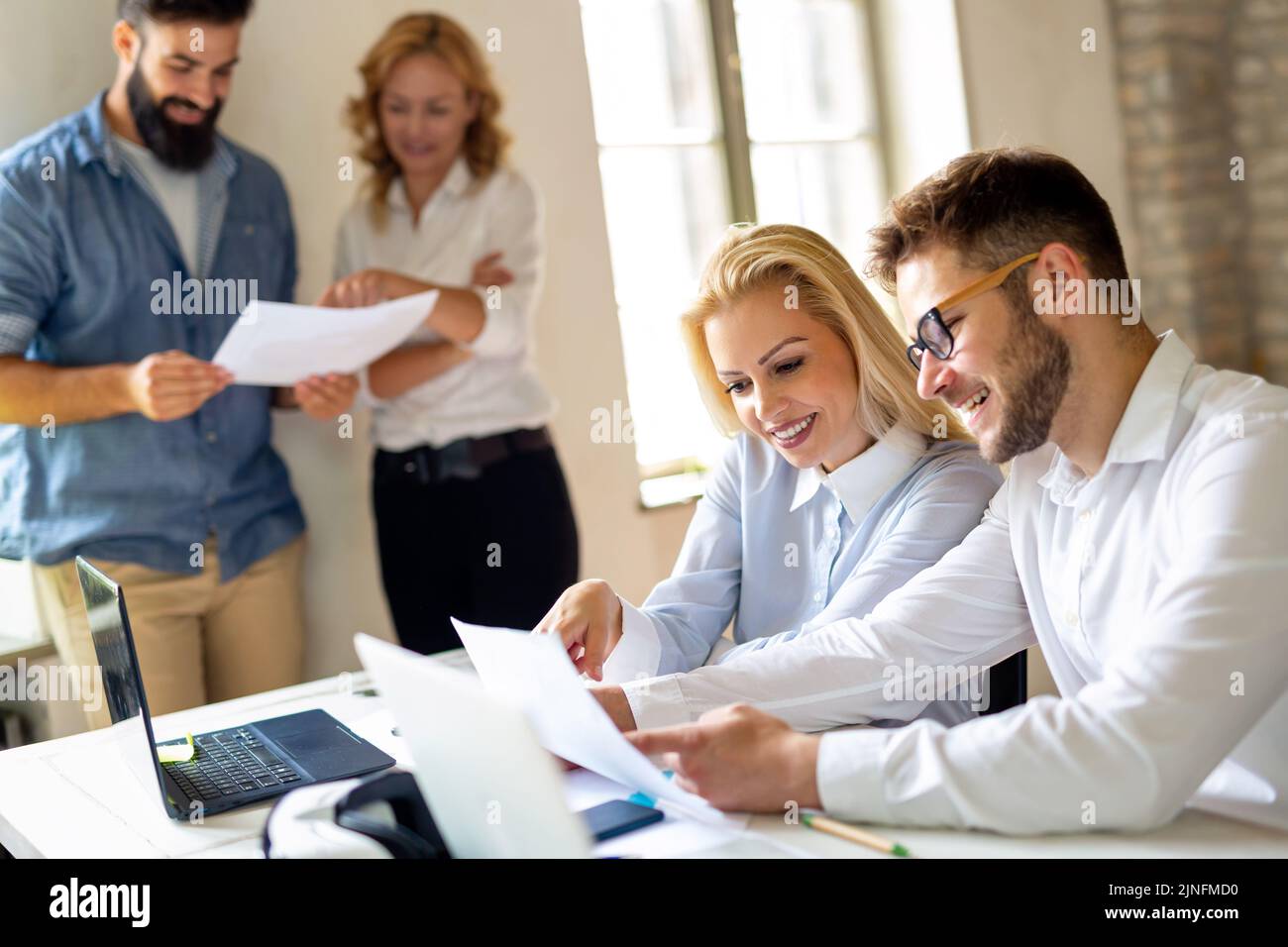 Working on new project together. Group of happy business people ...