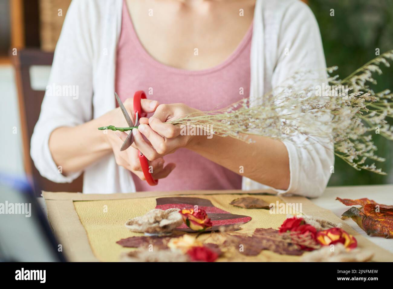 Unrecognizable woman wearing top and cardigan pruning roots of withered ...