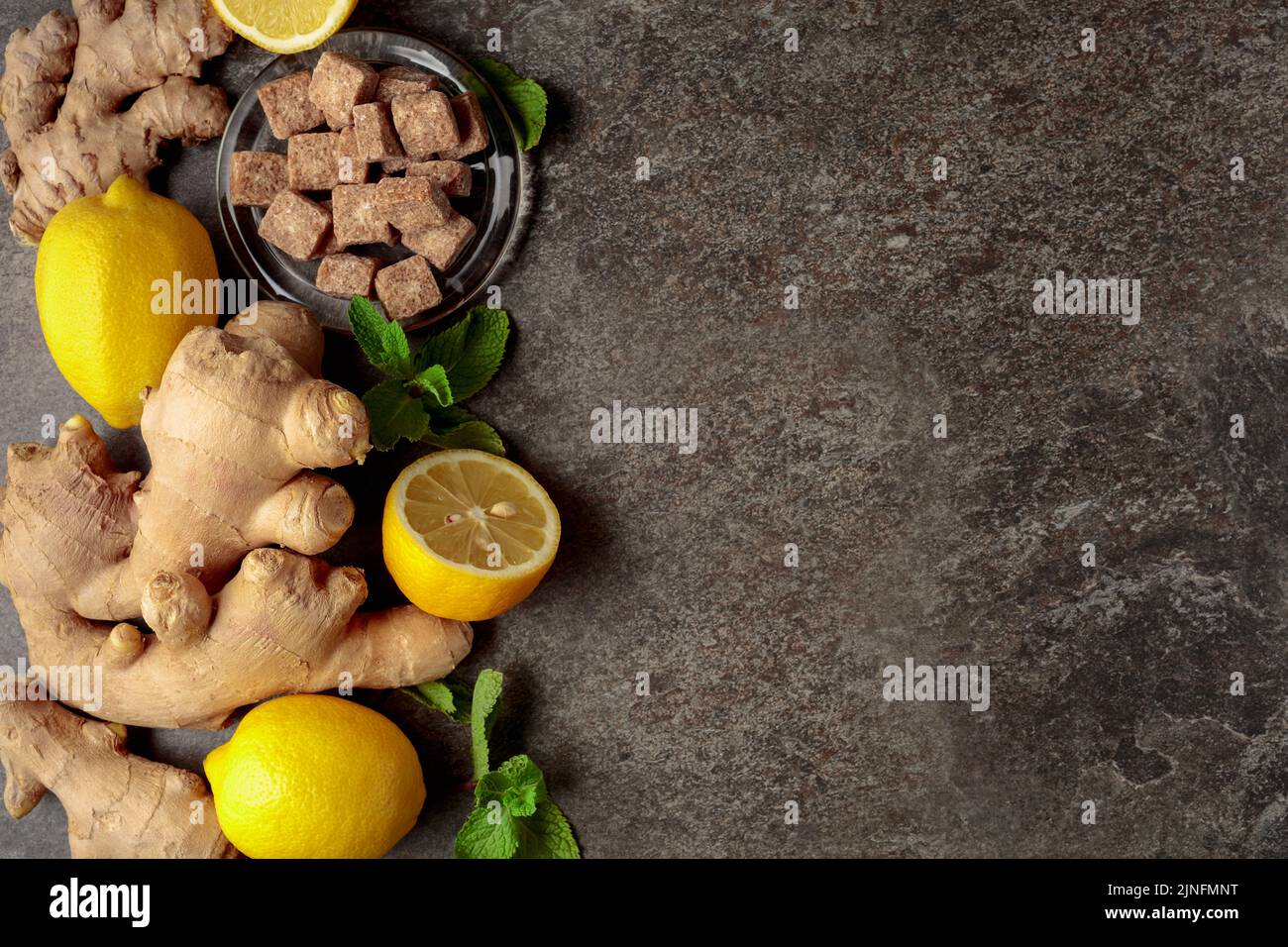 Ingredients for ginger tea. Ginger, lemon, mint and brown sugar on ...