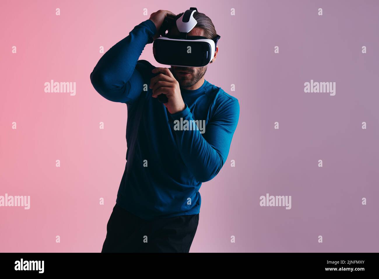 Boxing in virtual reality. sporty young man preparing for a virtual ...