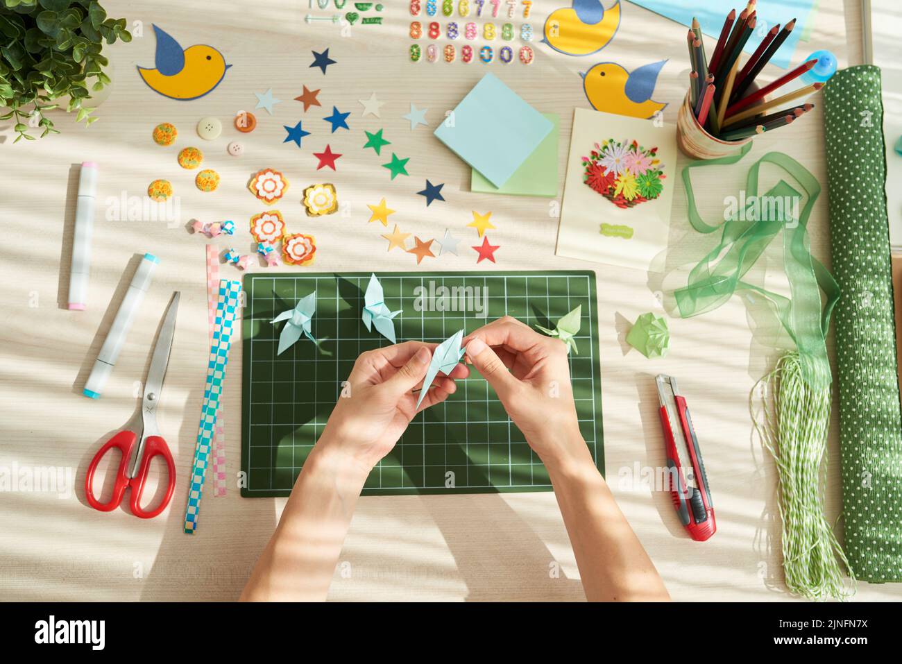 Woman making origami cranes hi-res stock photography and images - Alamy