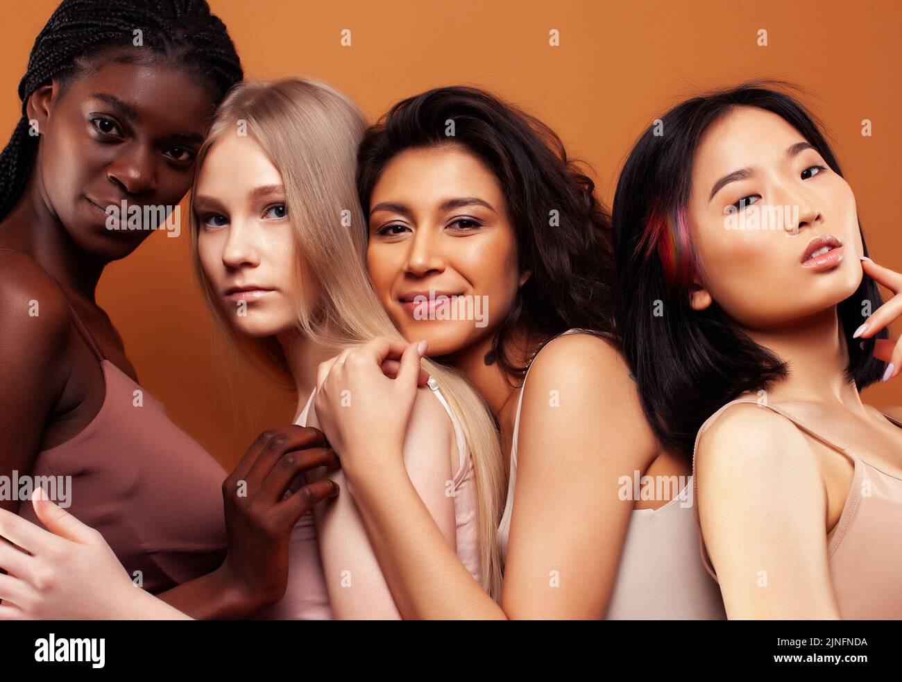 young pretty african and caucasian women posing cheerful together on ...
