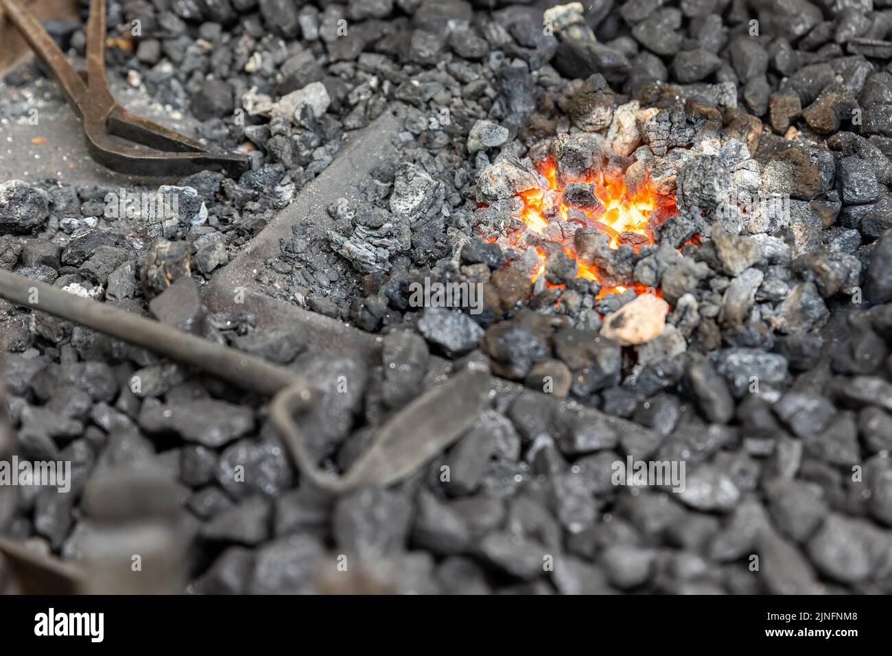 Close-up detail old medieval blacksmith furnace with hot burning coal ...