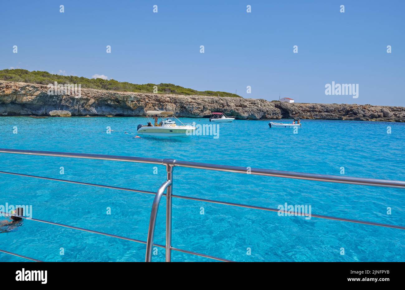 Menorca, Spain: Beautiful bay with sailing boat catamaran Stock Photo ...