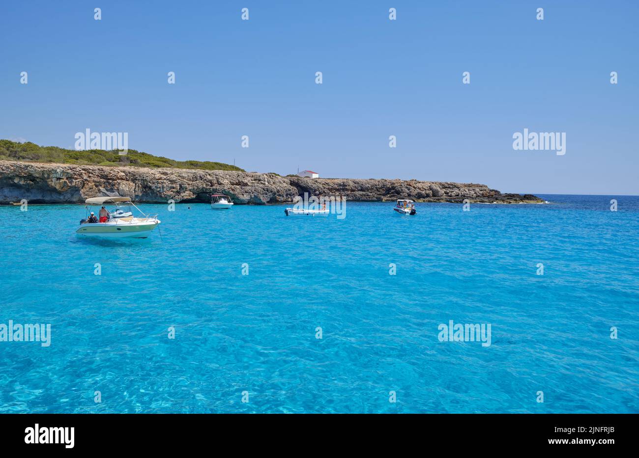 Menorca, Spain: Beautiful bay with sailing boat catamaran Stock Photo ...