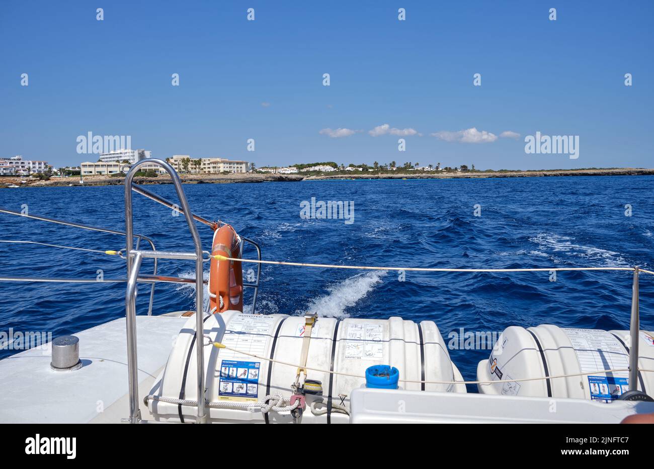 Menorca, Spain: Beautiful bay with sailing boat catamaran Stock Photo ...