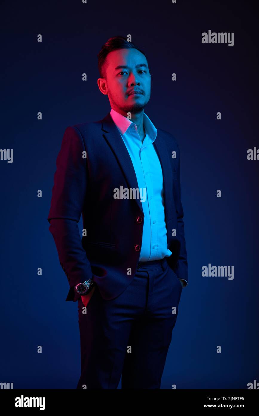 Portrait of confident Vietnamese businessman in dark studio Stock Photo ...
