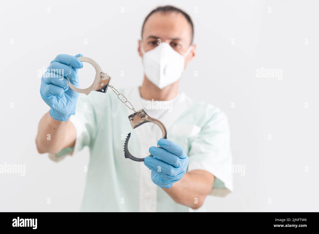 Corona virus prevention face masks at home. Hands in handcuffs medical ...