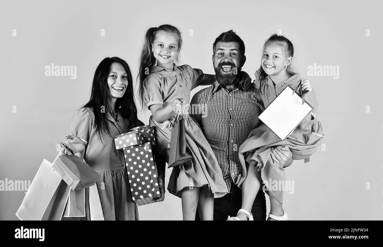 happy family go shopping together hold packages, sales Stock Photo - Alamy