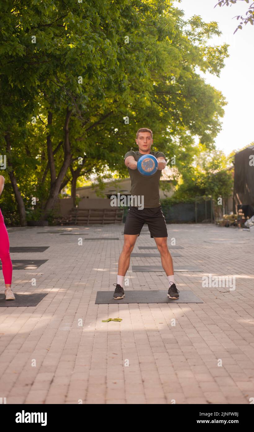 Beautiful and sweet couple are training together and doing a exercise ...