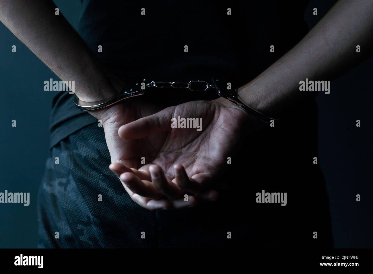 Woman hands in handcuffs behind back hi-res stock photography and ...