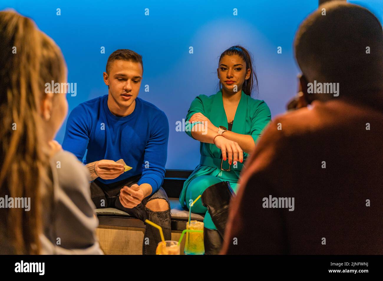 Handsome and strong guy is explaining the word so they can guess it ...