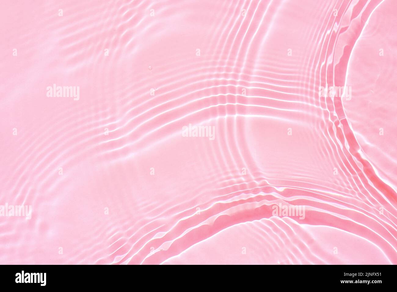Background, texture of transparent pink water with ripples and waves ...