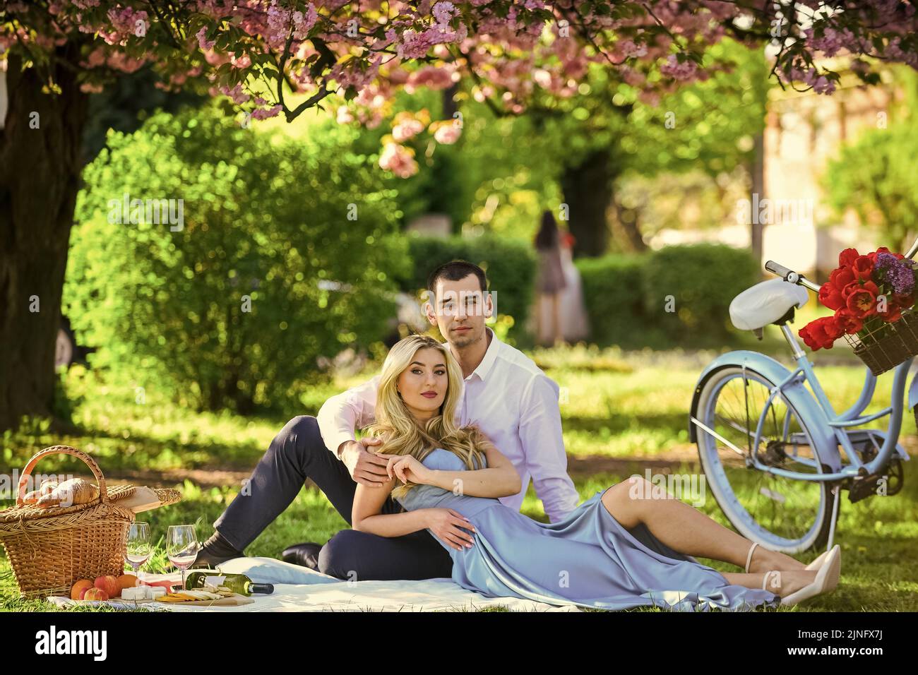 First meet. summer holiday trip. girl and man under sakura. couple in ...